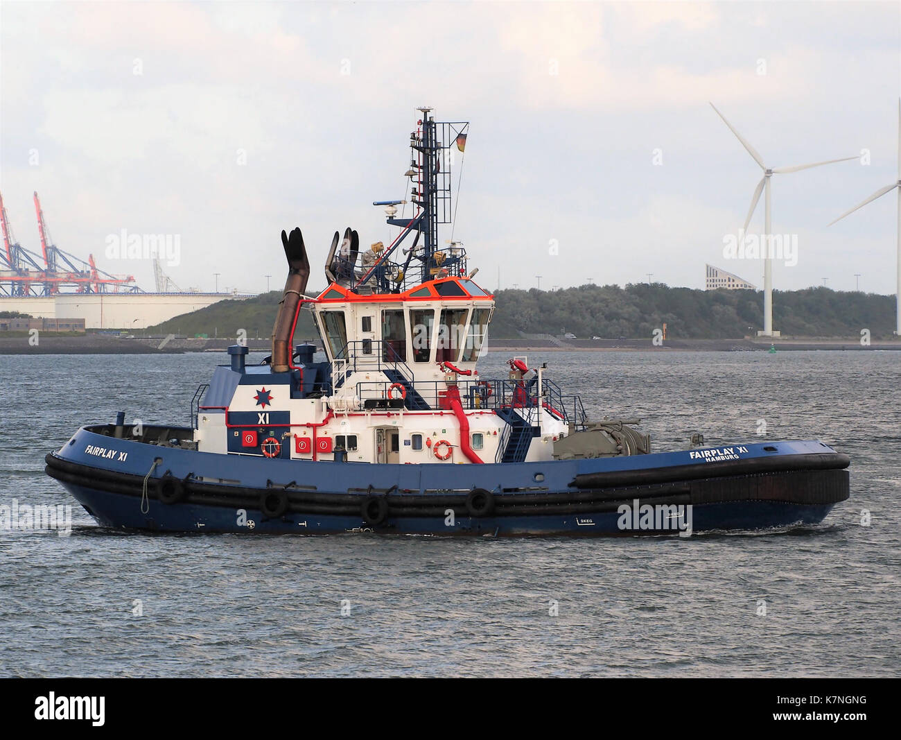 The image shows the tugboat Fairplay XI, built in 2015, navigating the ...