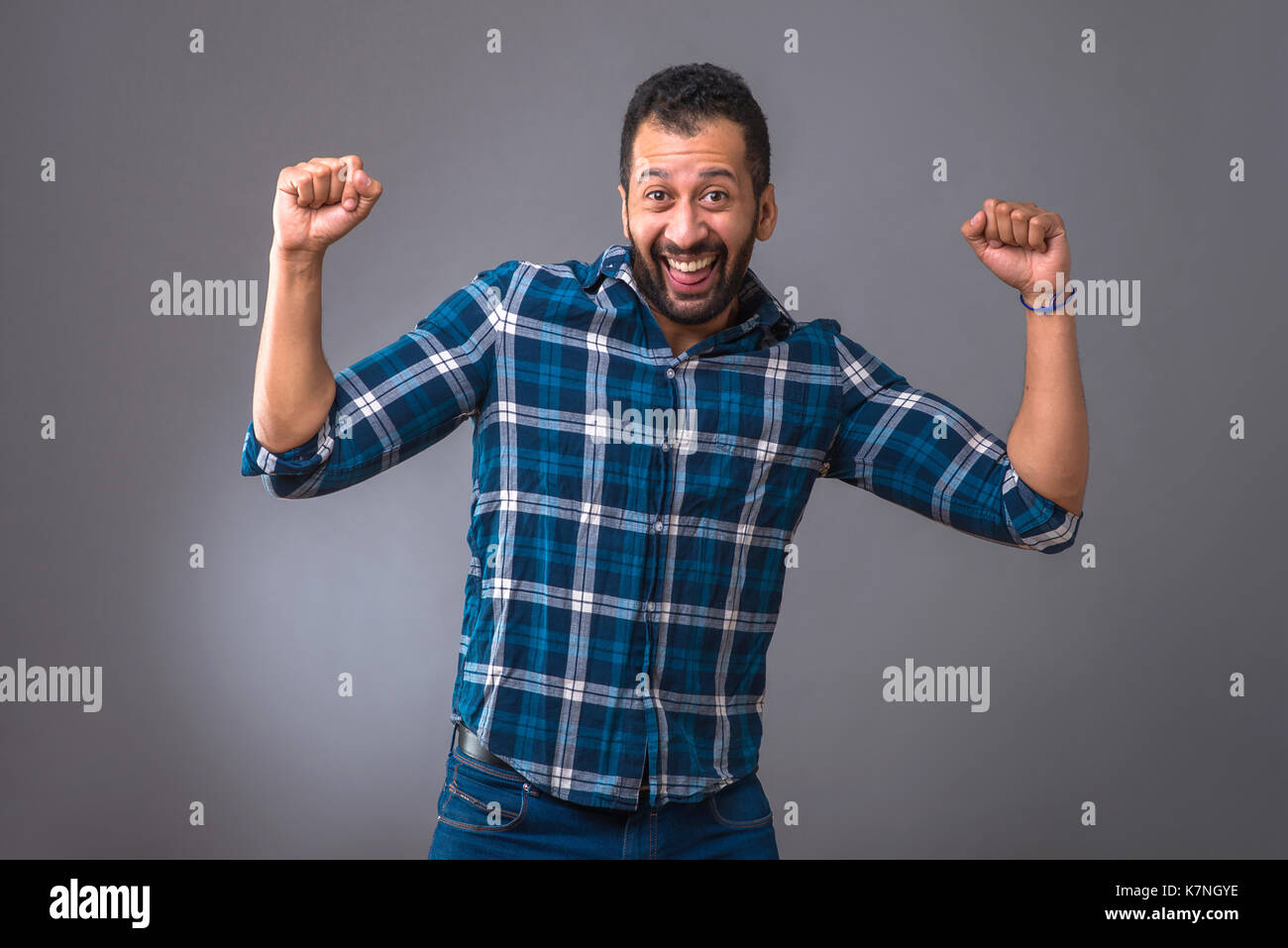 A young black man smiling and celebrating Stock Photo - Alamy