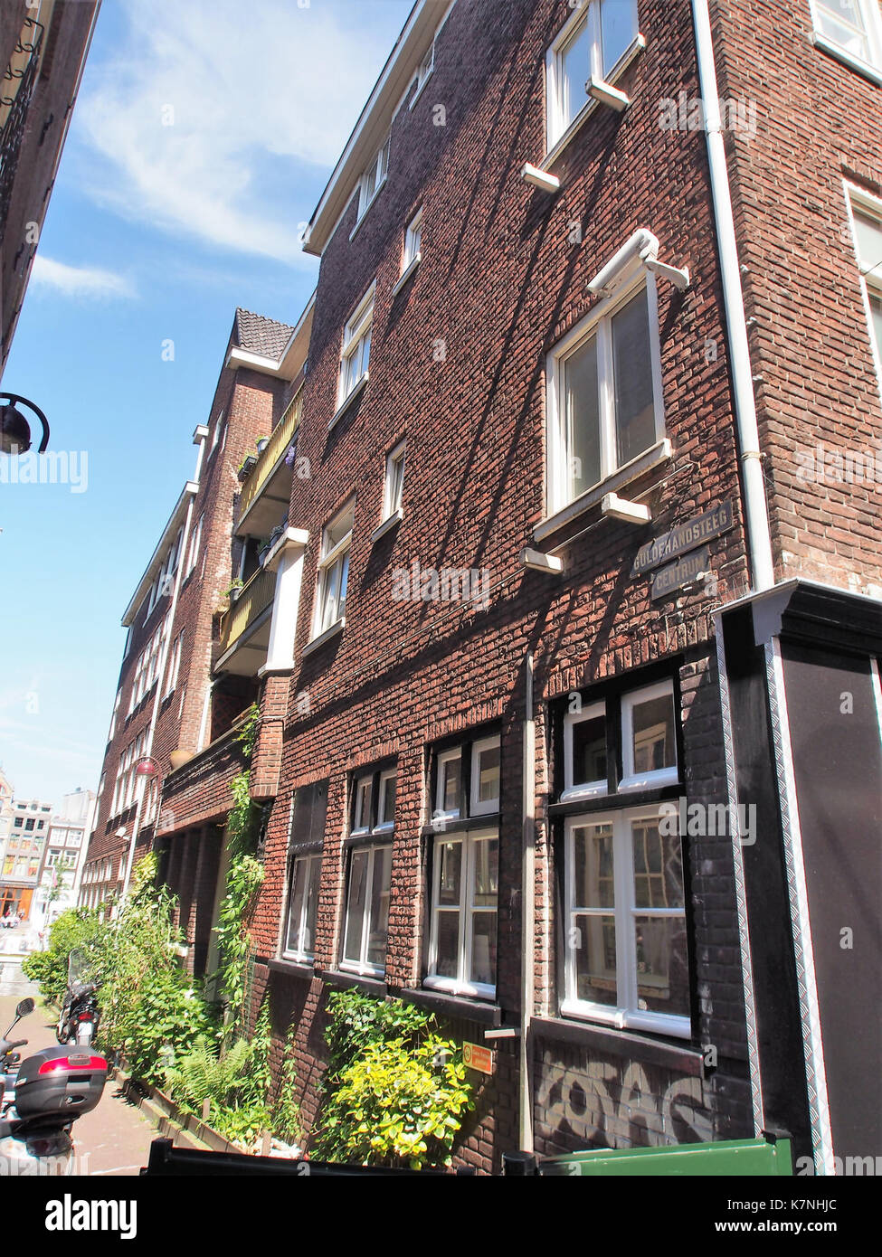 The photograph depicts Guldehandsteeg, a narrow street in a European ...