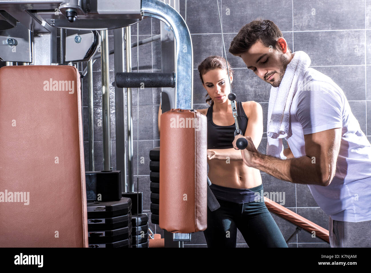 A young couple training together in the Gym Stock Photo - Alamy