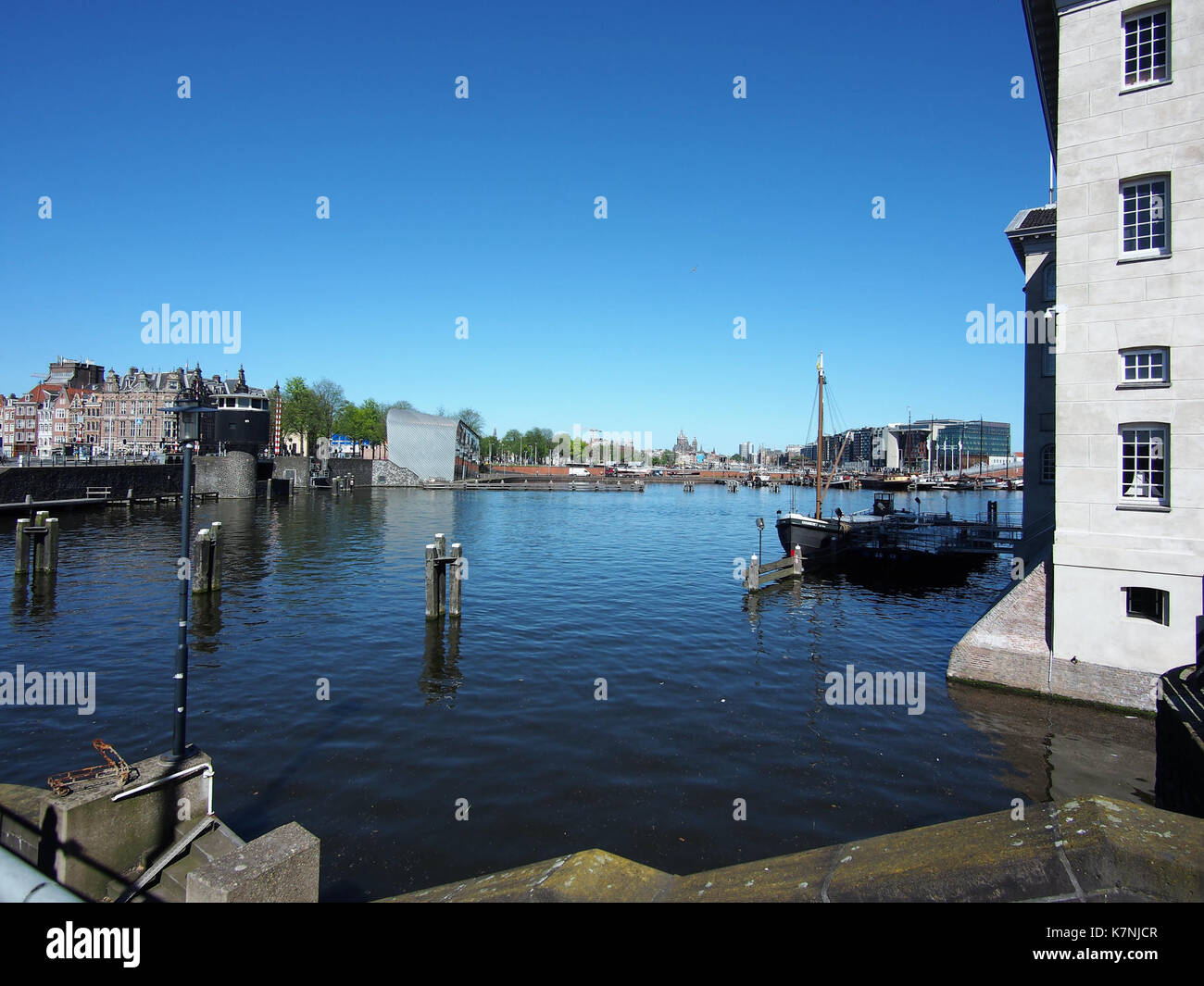 This photograph captures the Oosterdok, a harbor area in Amsterdam ...