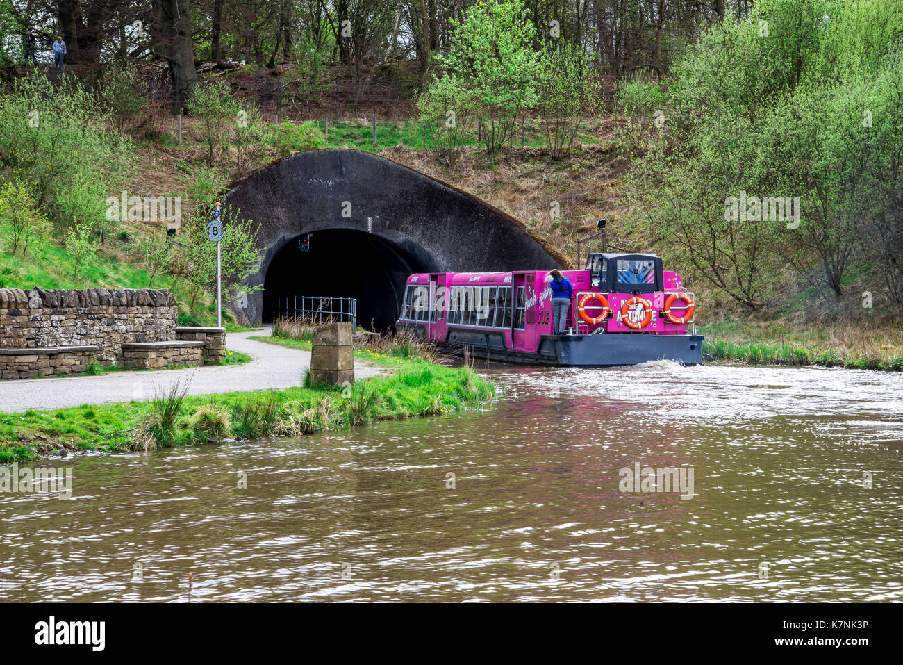 A tourist ferry boat enters a tunnel from Falkirk Wheel boat lift to ...