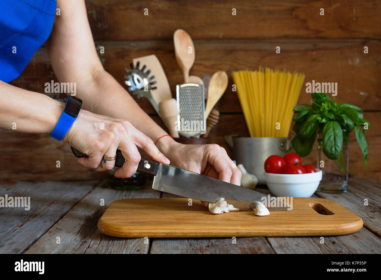 A female chef chops mushrooms american traditional food Stock Photo - Alamy
