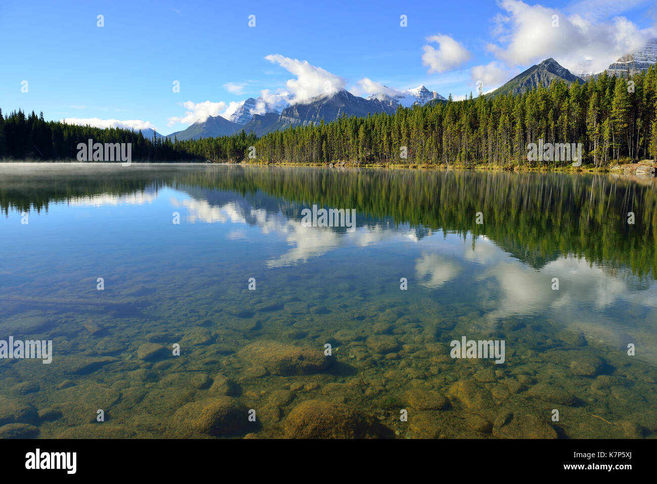 Beautiful high mountains of the Canadian Rockies reflecting in an ...