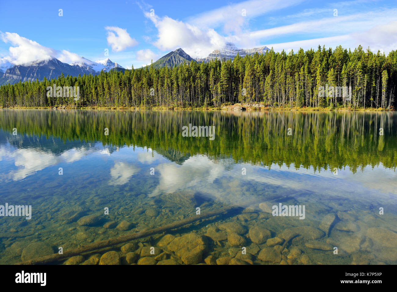Beautiful high mountains of the Canadian Rockies reflecting in an ...