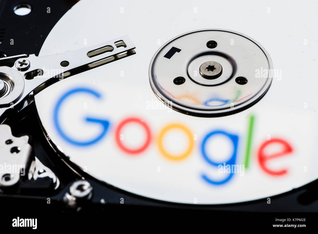 Close-up of an opened computer hard drive disk, with reflection of the ...