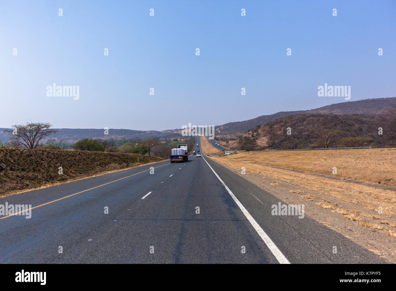 Drivers View travelling road highway with vehicles route through ...