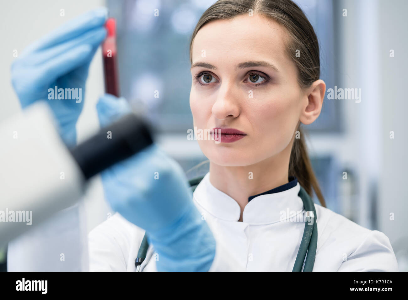 Doctor looking test tube blood hi-res stock photography and images - Alamy