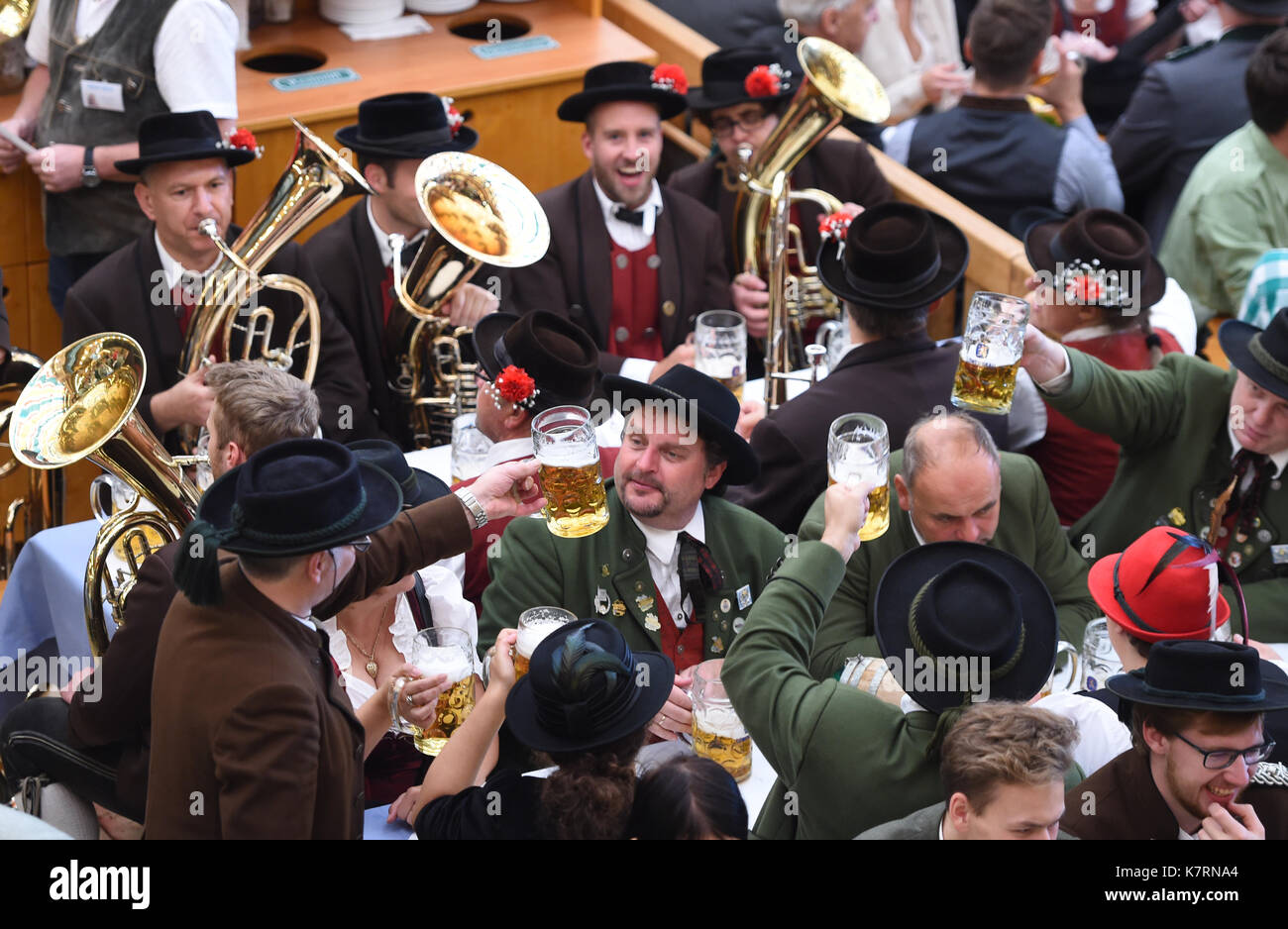Munich, Germany. 17th Sep, 2017. People wearing traditional attire sit ...