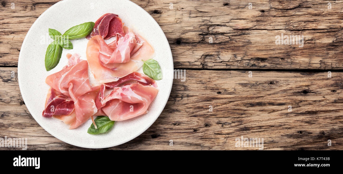 Sliced of Traditional Spanish jamon on a wooden retro background Stock ...