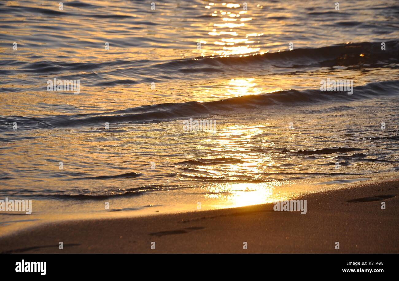 Sunset Reflecting on Water in Honolulu Stock Photo - Alamy
