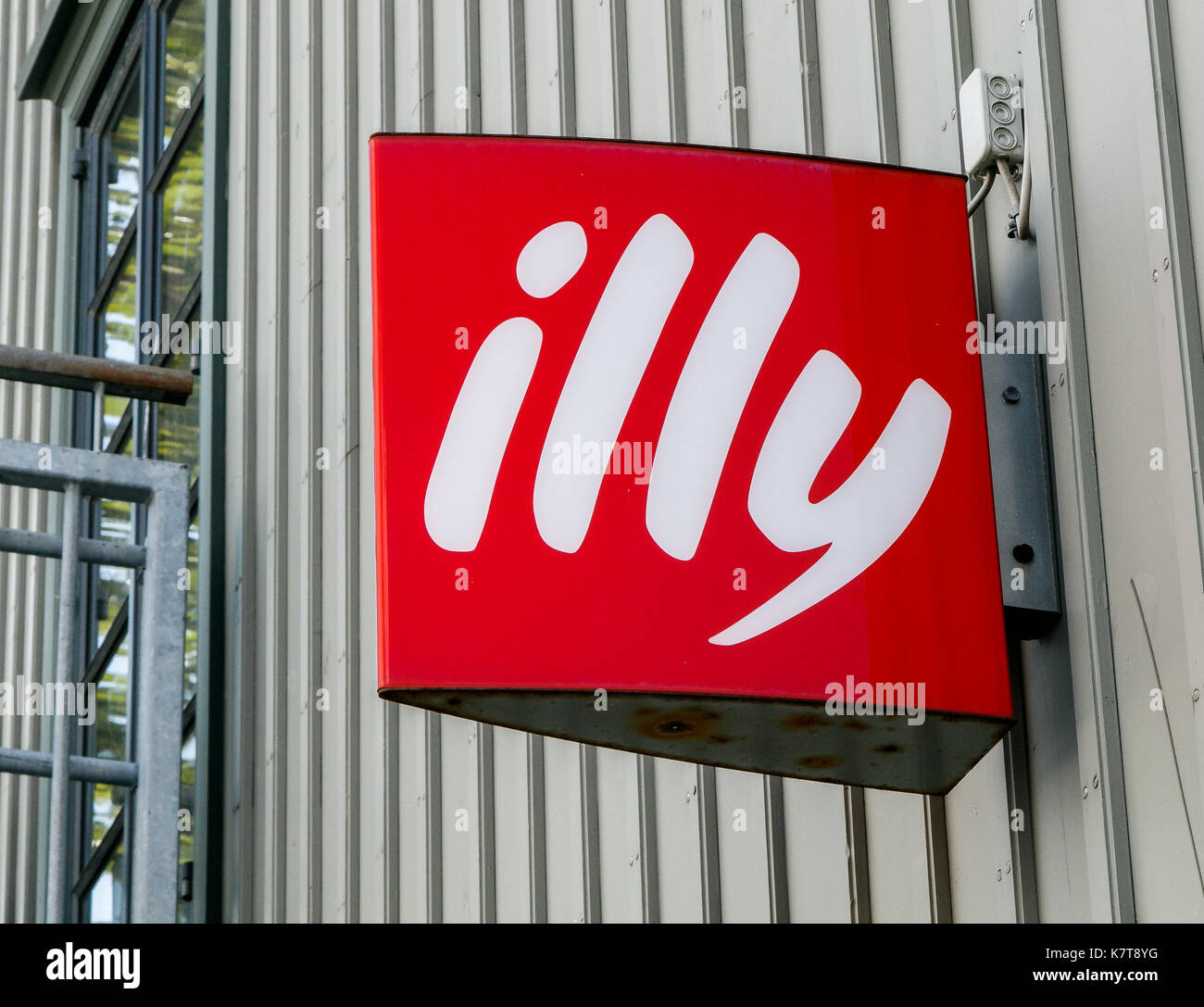 Illy logo is mounted to a wall above the entrance to one of their ...
