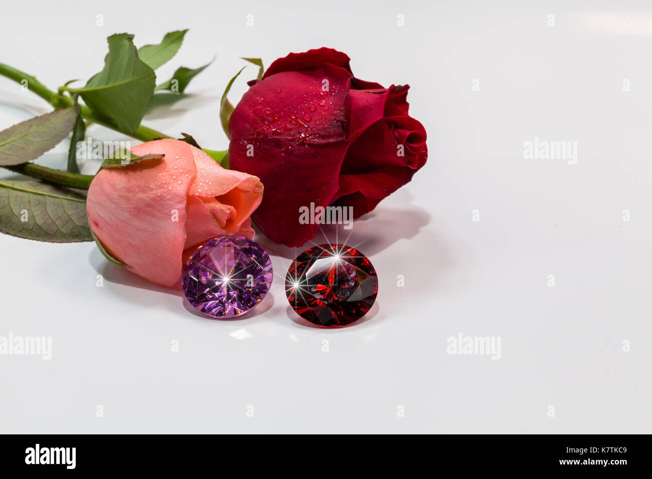 light pendant shine on pink and red gems stones on white background ...