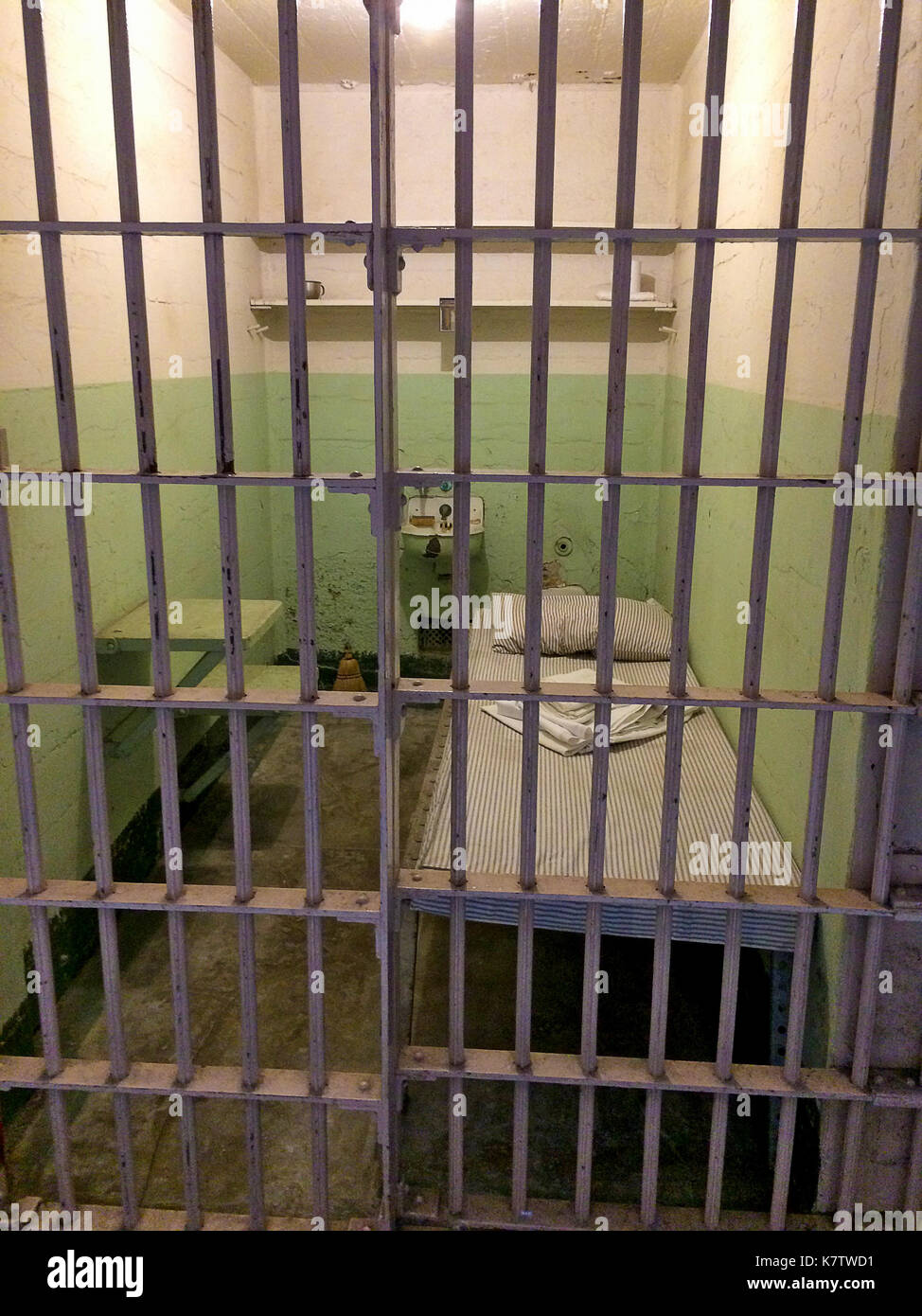 grungy vacant prison cell with rusty bars Stock Photo - Alamy