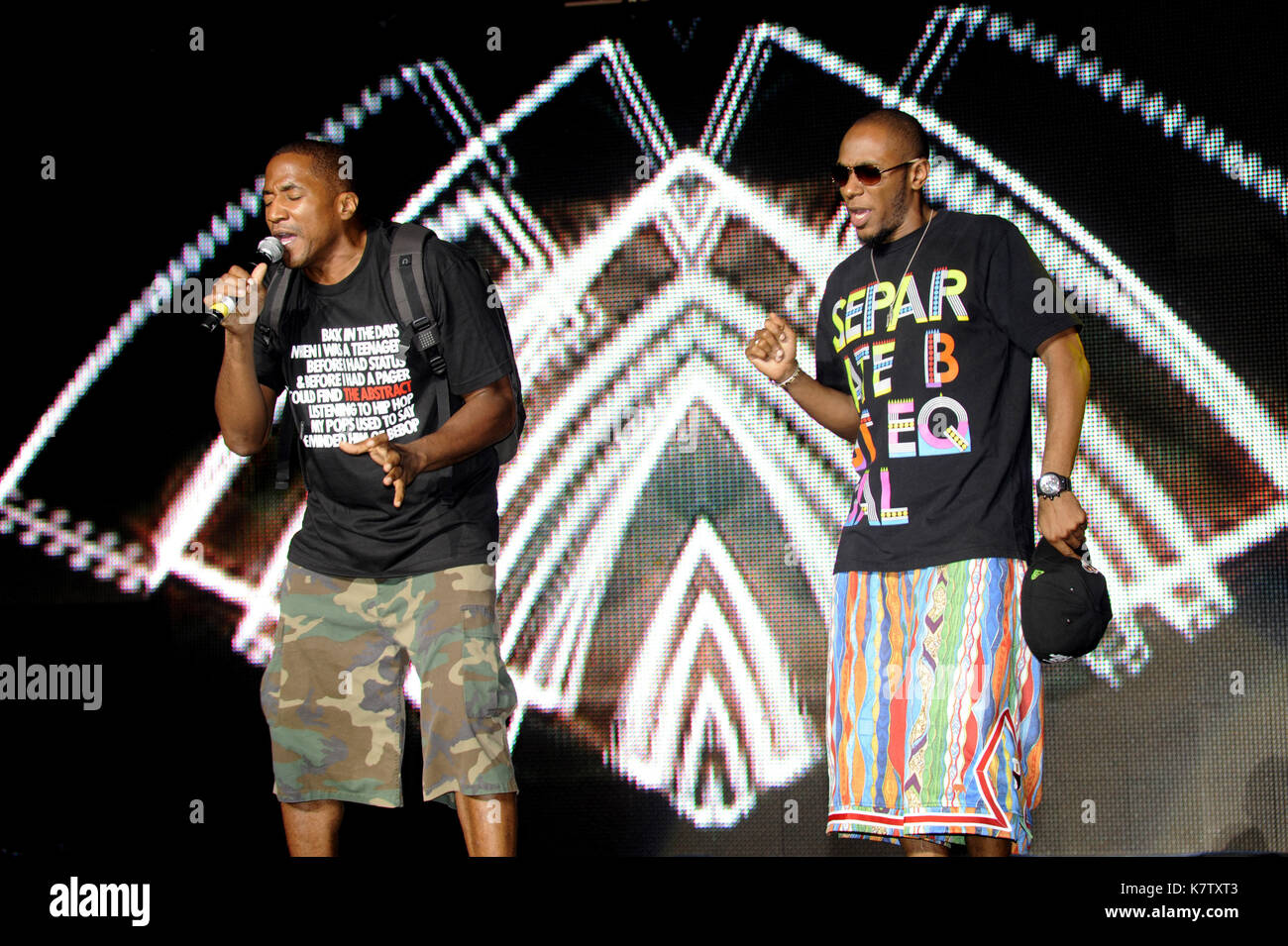 Mos Def (at right) performing with A Tribe Called Quest (Q-Tip, at left ...