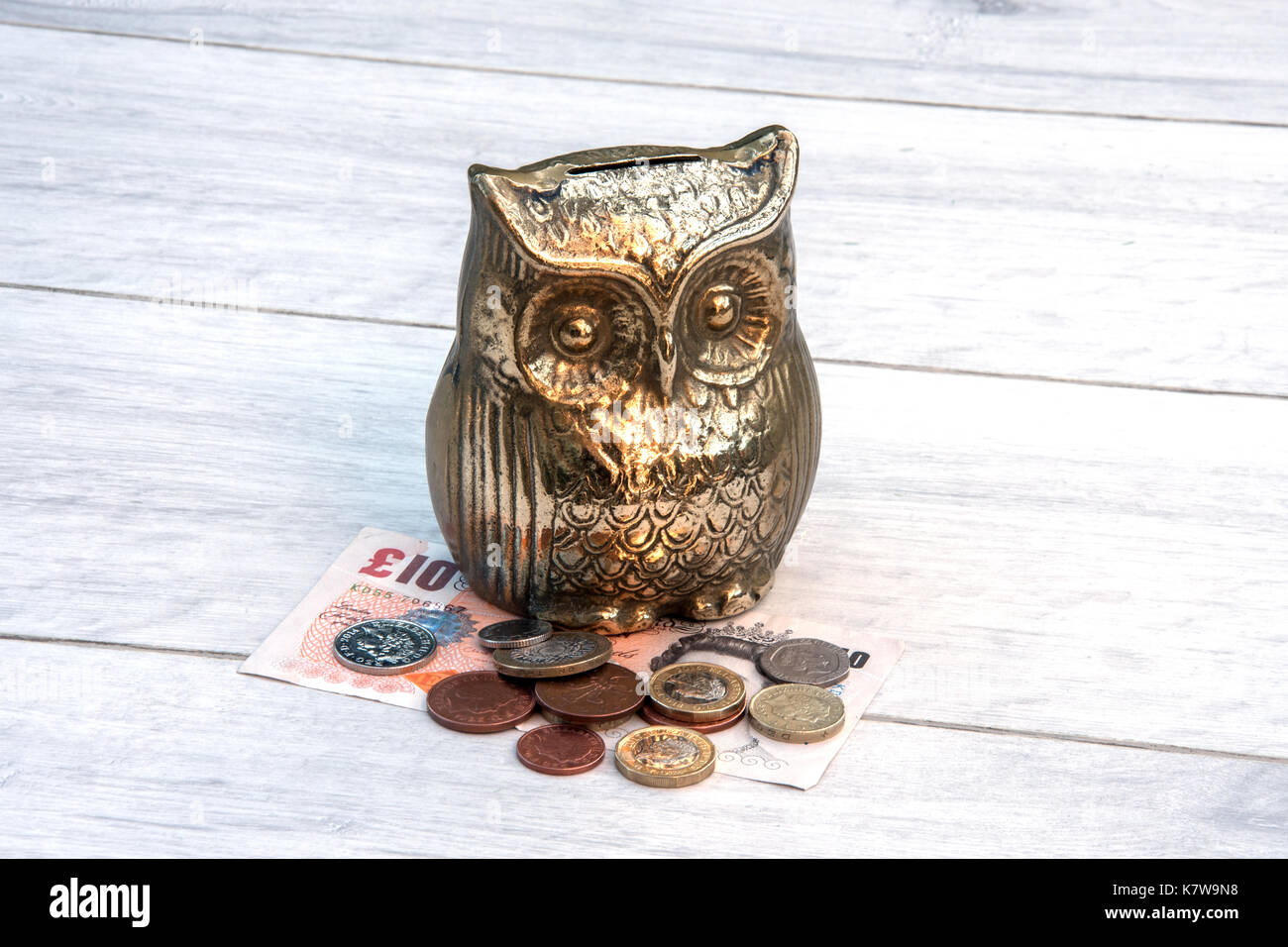 Owl money box with UK sterling money Stock Photo - Alamy