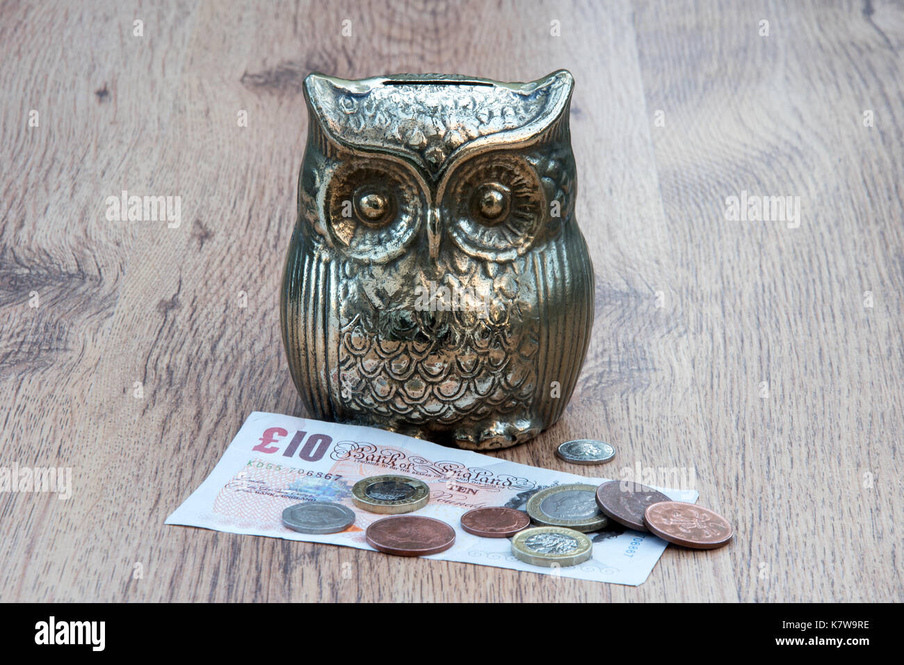 Owl money box with UK sterling money Stock Photo - Alamy