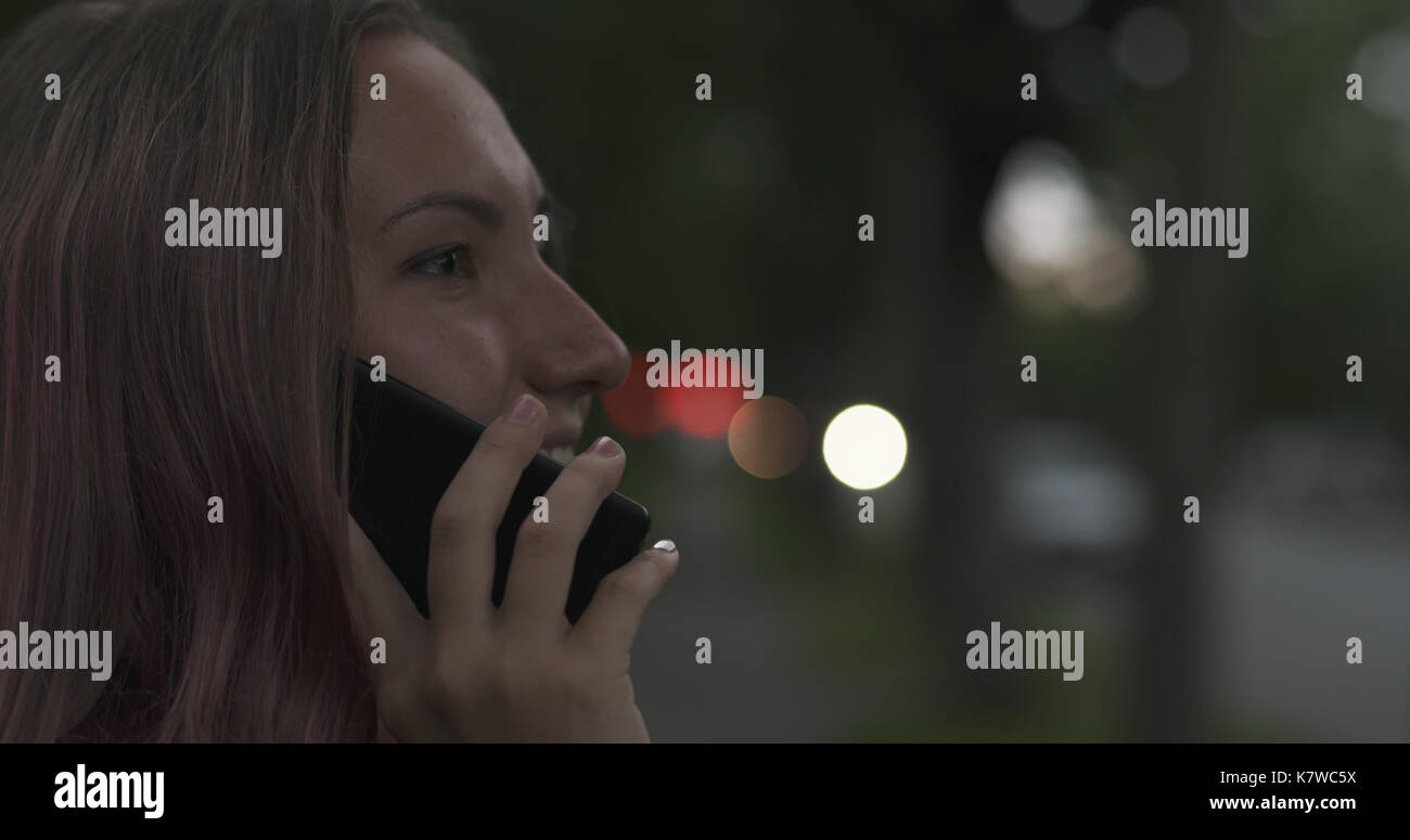 female teen talking on the phone on the street at night Stock Photo - Alamy