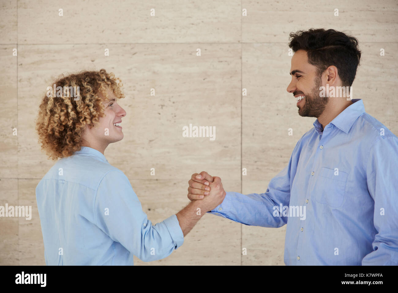 Standing smiling shaking hands fashion model hi-res stock photography ...