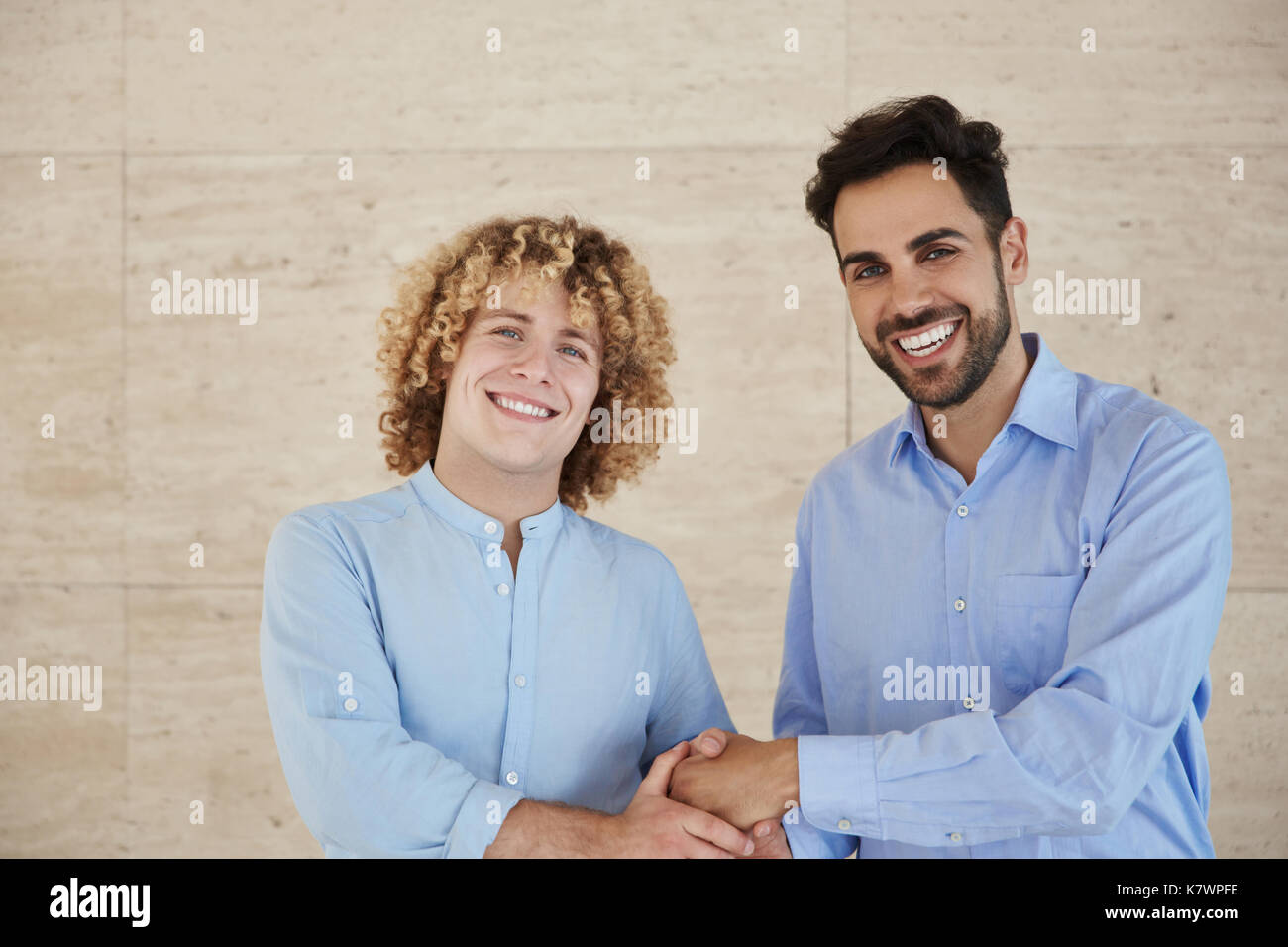 Standing smiling shaking hands fashion model hi-res stock photography ...