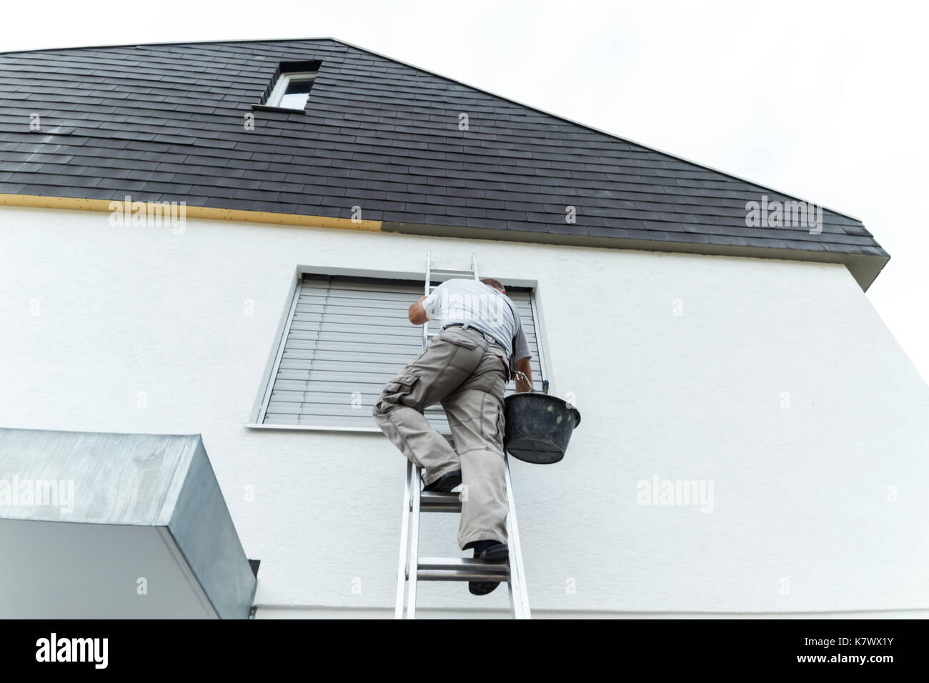 Construction climbing ladder up roof hi-res stock photography and ...