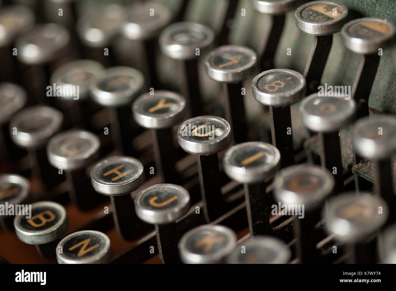 very old dusty typewriter with round keys background Stock Photo - Alamy