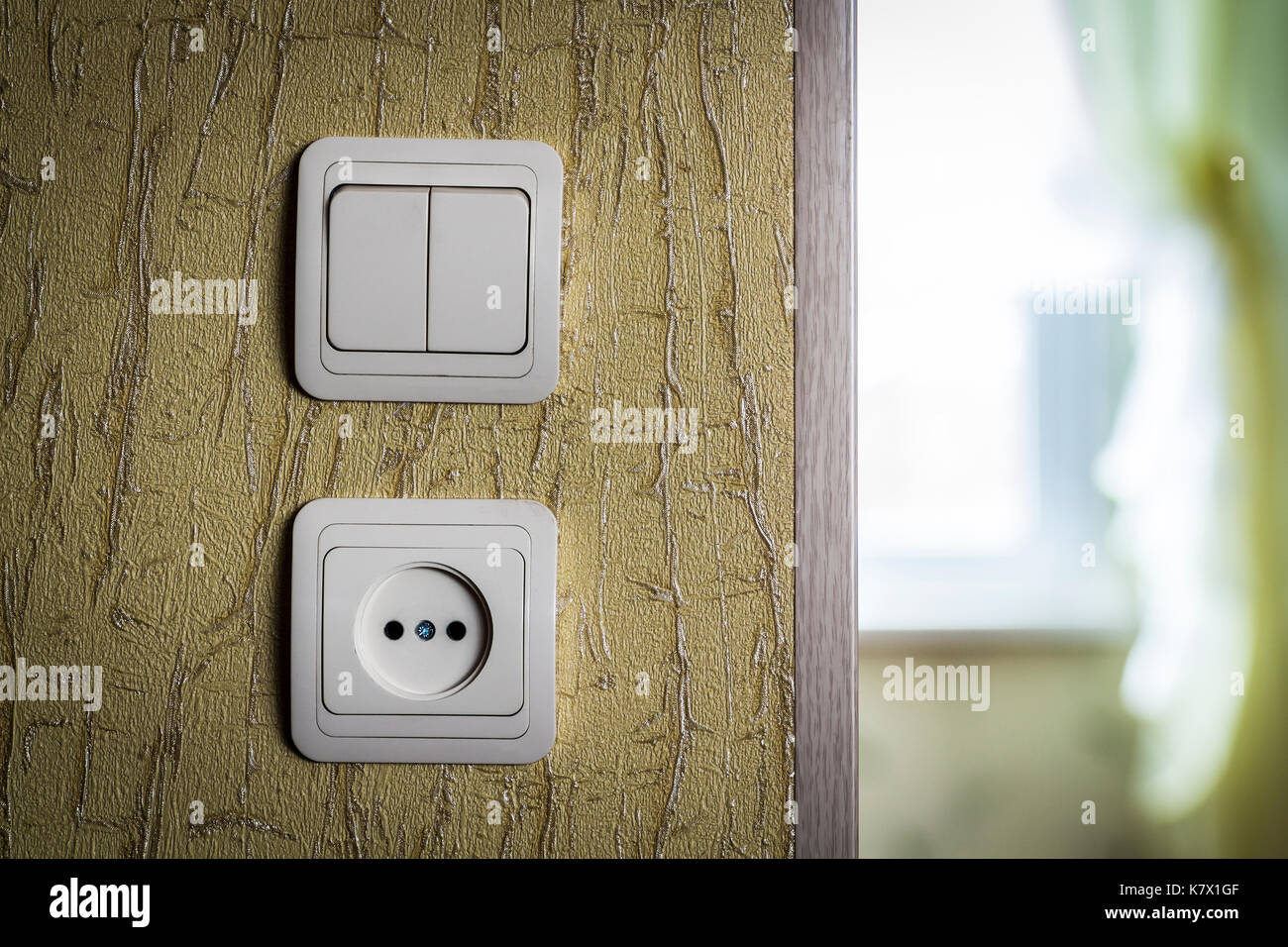Wall Plastic electrical outlet and switch closeup Stock Photo - Alamy