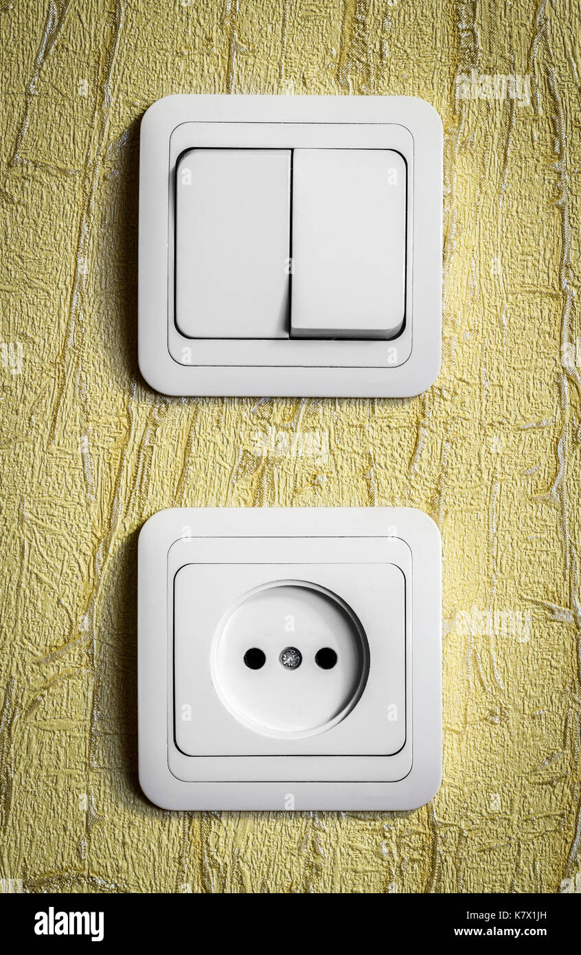 Wall Plastic electrical outlet and switch closeup Stock Photo - Alamy