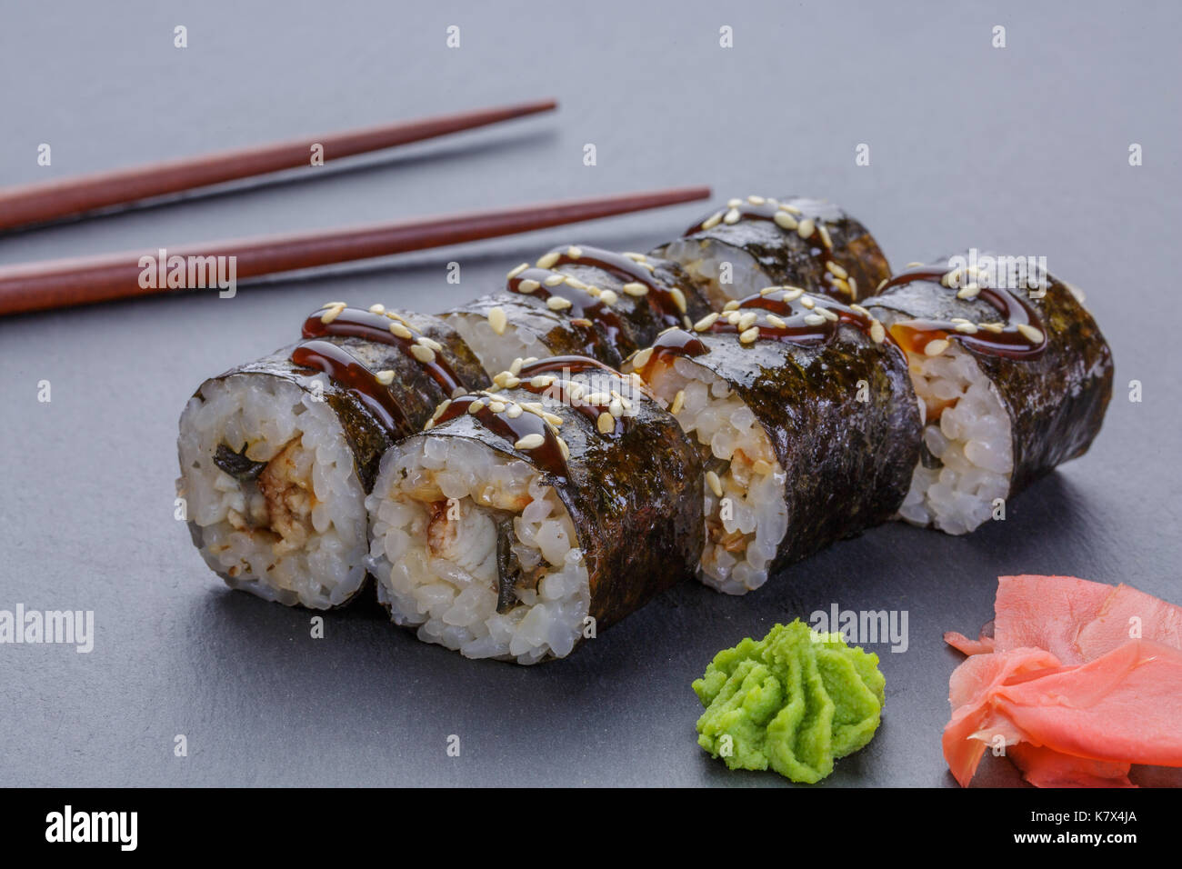 Traditional japanese rolls with wasabi and ginger on a black background ...