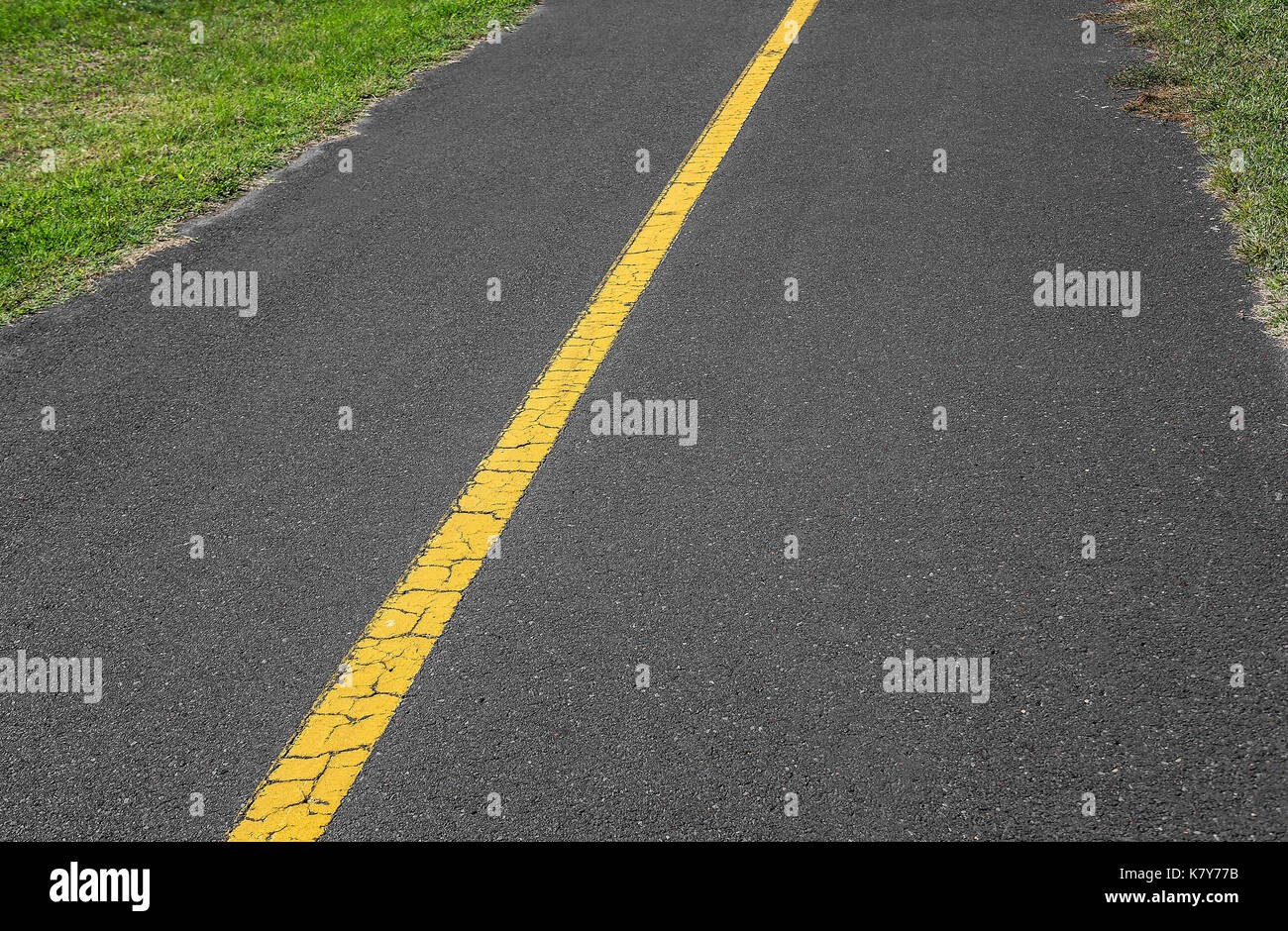 Asphalted path with yellow markings Stock Photo - Alamy