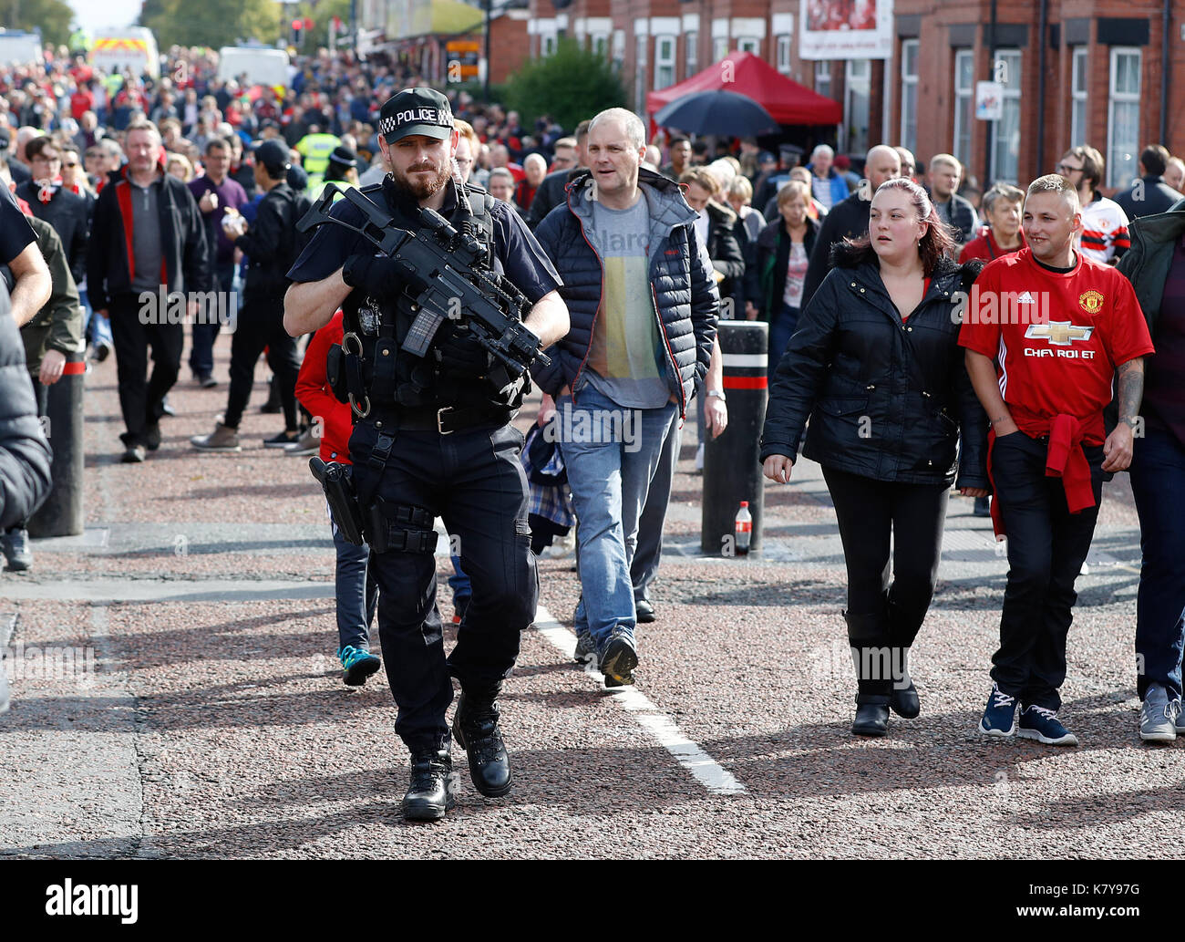 Armed police watch over fans outside the ground before the Premier ...