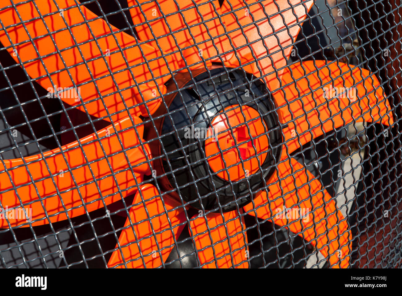 orange fan with safety metal net, close up Stock Photo - Alamy