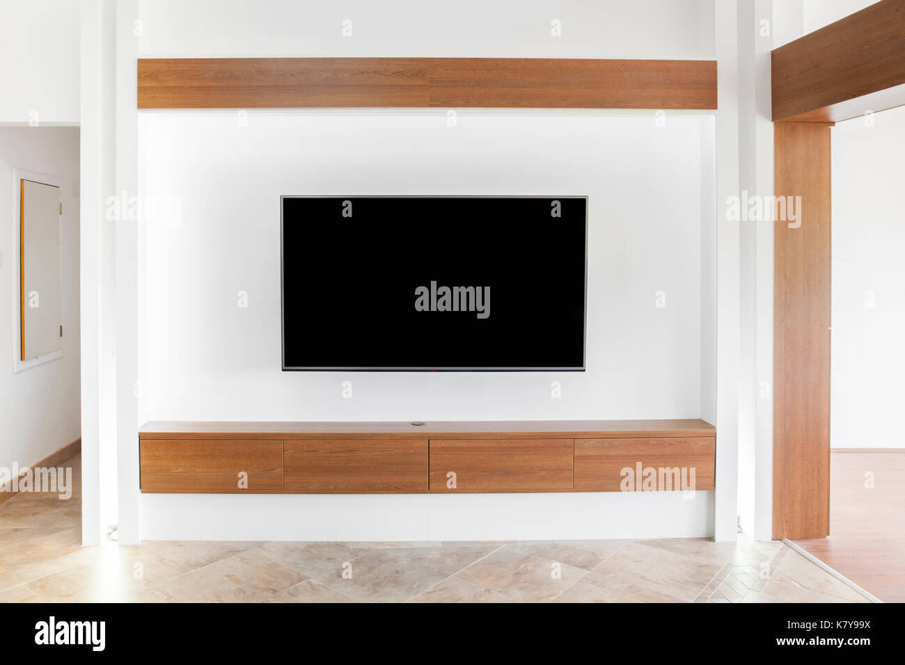 big led TV on white wall with wooden shelf Stock Photo - Alamy
