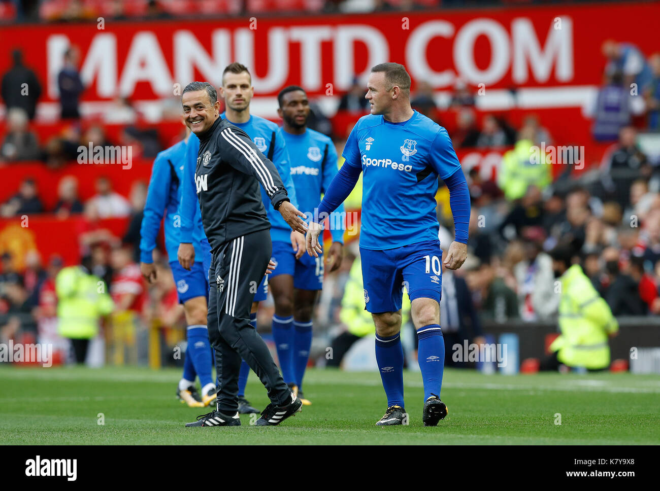 Everton's Wayne Rooney shakes hands with Ricardo Formosinho, one of his ...
