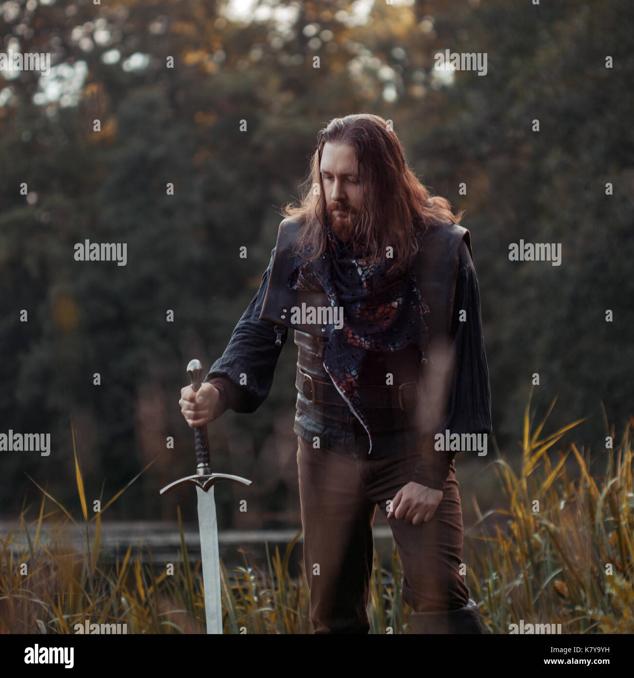 The bearded man knight. A guy in a medieval costume with a sword Stock ...