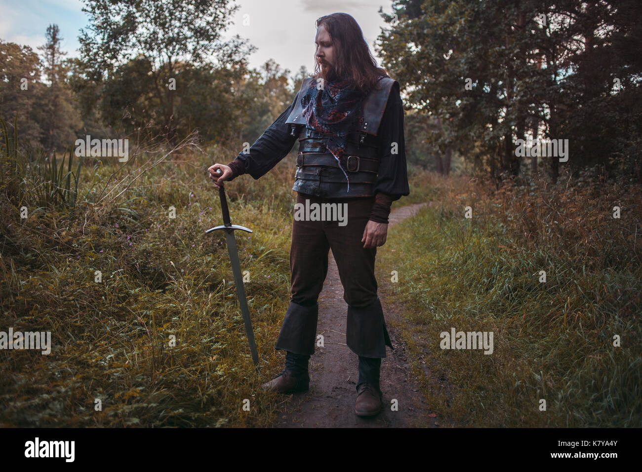 The bearded man knight. A guy in a medieval costume with a sword Stock ...