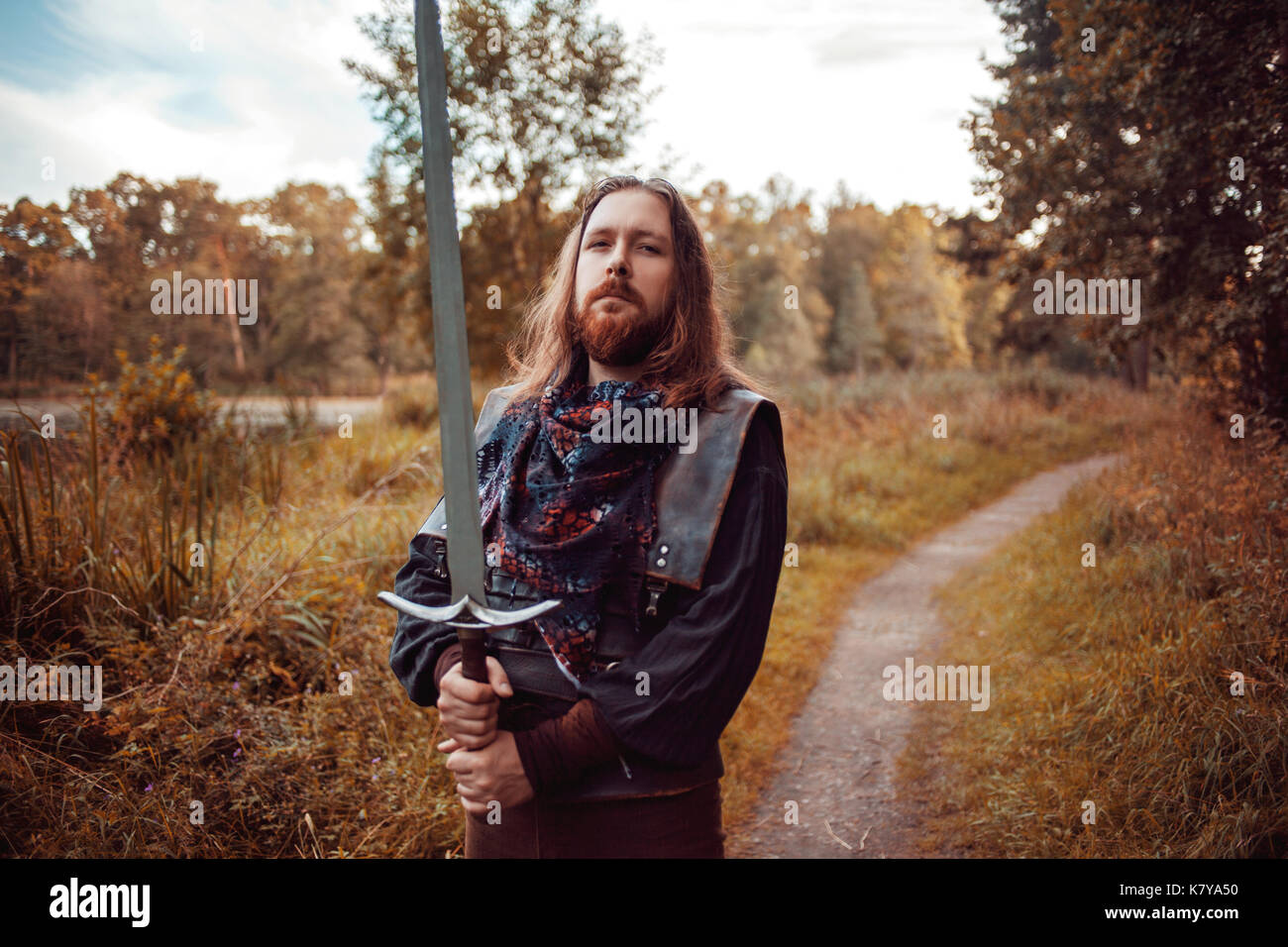 The bearded man knight. A guy in a medieval costume with a sword Stock ...