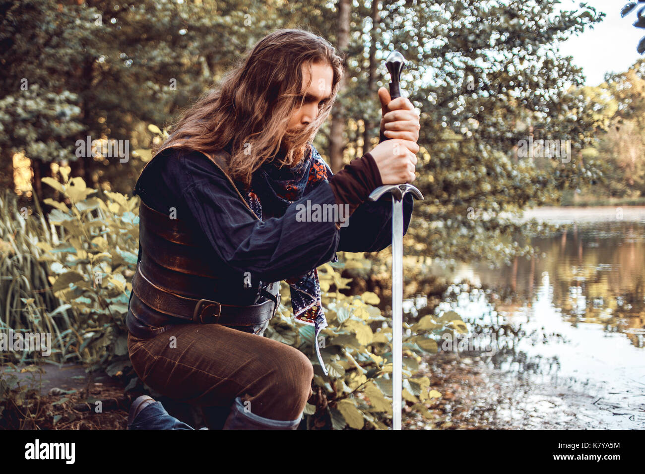 The bearded man knight. A guy in a medieval costume with a sword Stock ...