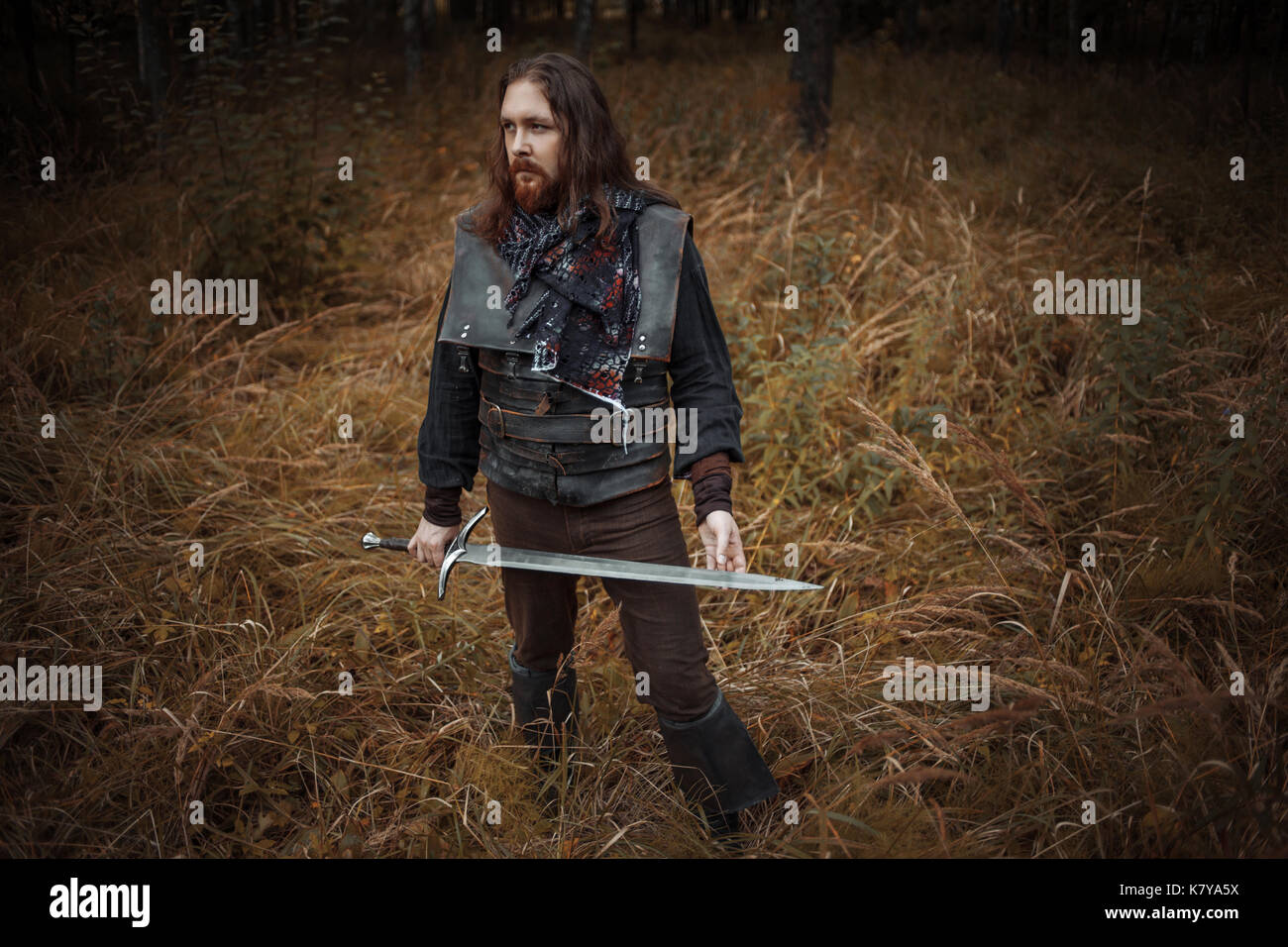 The bearded man knight. A guy in a medieval costume with a sword Stock ...