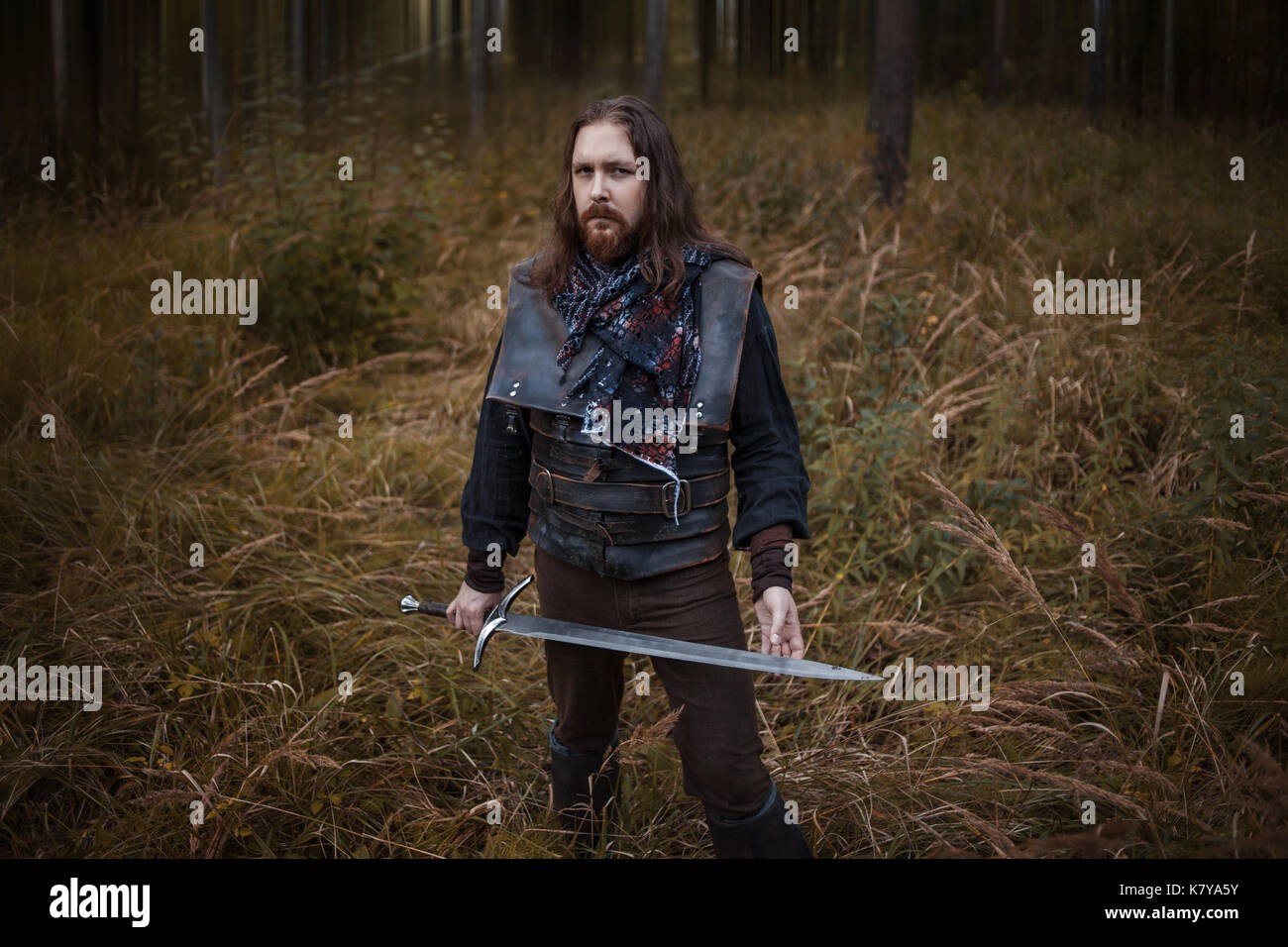 The bearded man knight. A guy in a medieval costume with a sword Stock ...