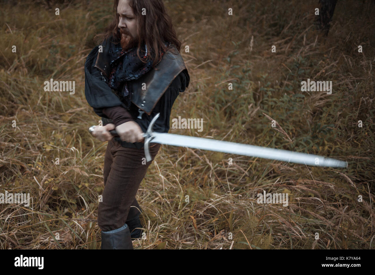 The bearded man knight. A guy in a medieval costume with a sword Stock ...