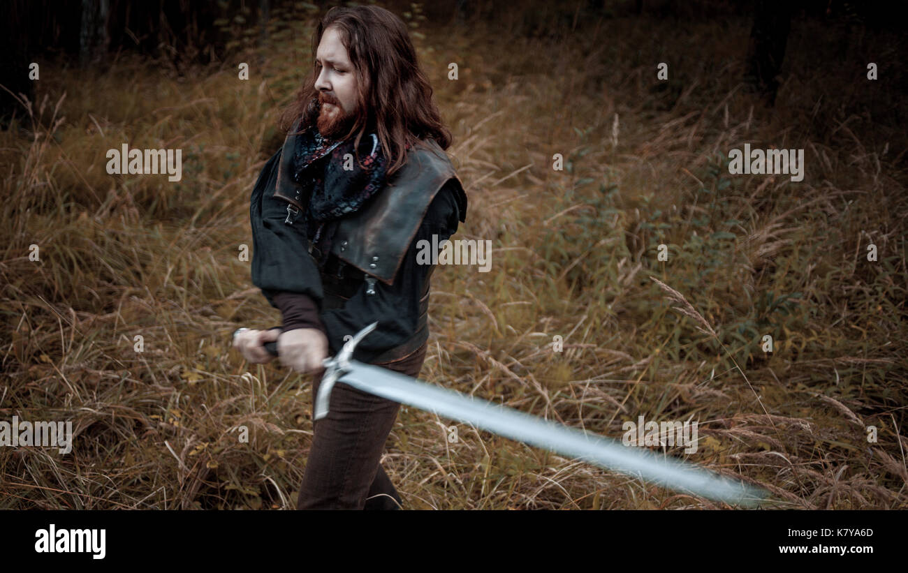 The bearded man knight. A guy in a medieval costume with a sword Stock ...