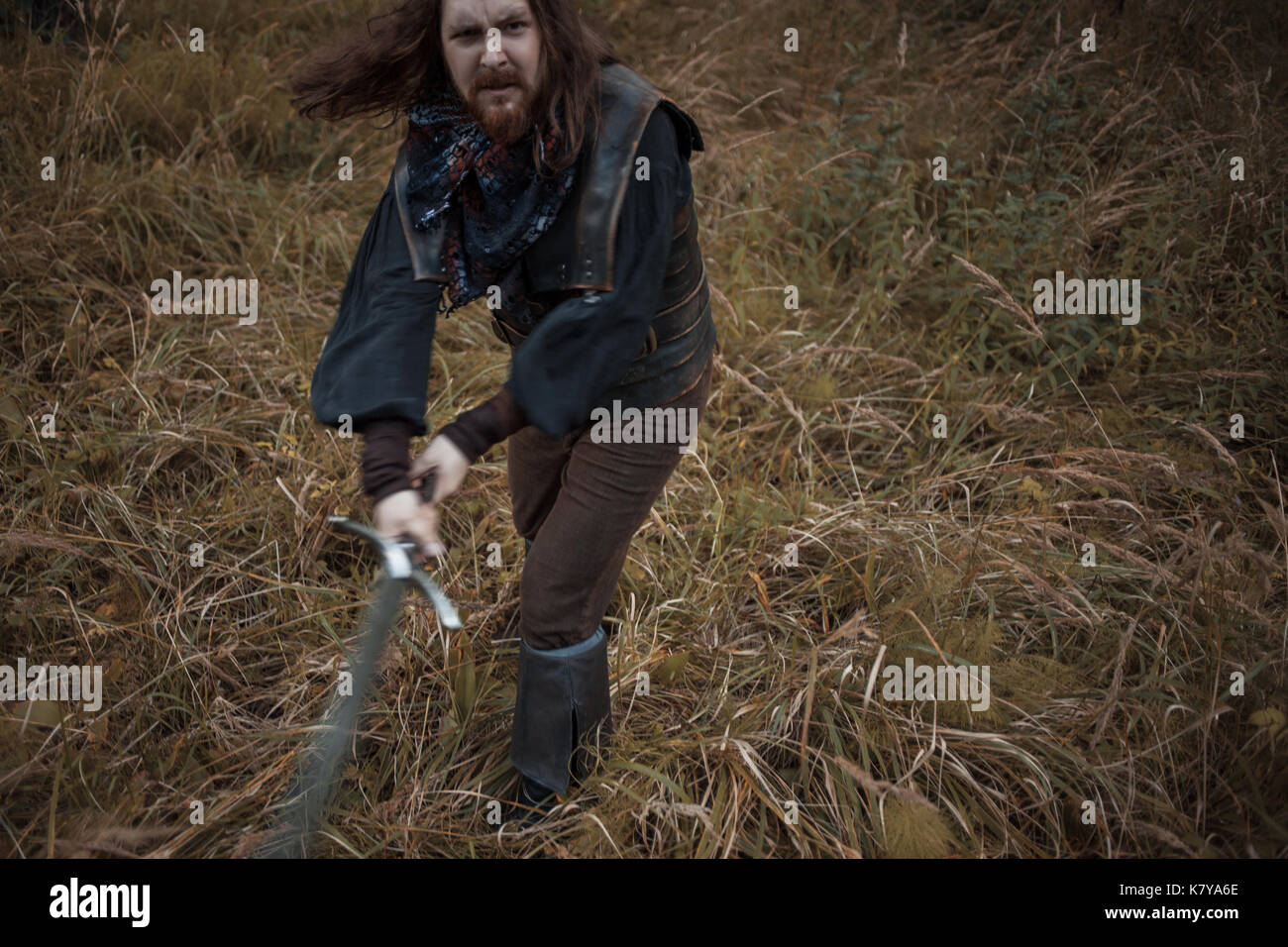 The bearded man knight. A guy in a medieval costume with a sword Stock ...