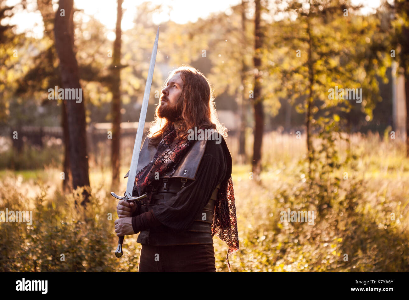 The bearded man knight. A guy in a medieval costume with a sword Stock ...