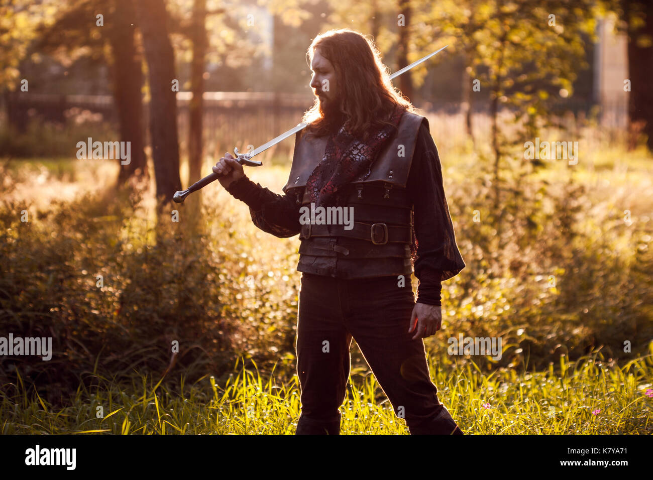 The bearded man knight. A guy in a medieval costume with a sword Stock ...