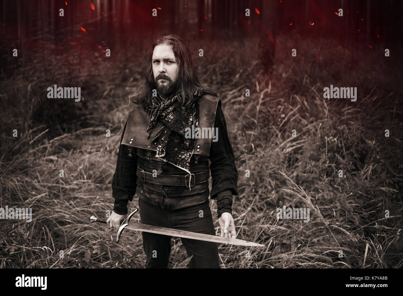 The bearded man knight. A guy in a medieval costume with a sword Stock ...