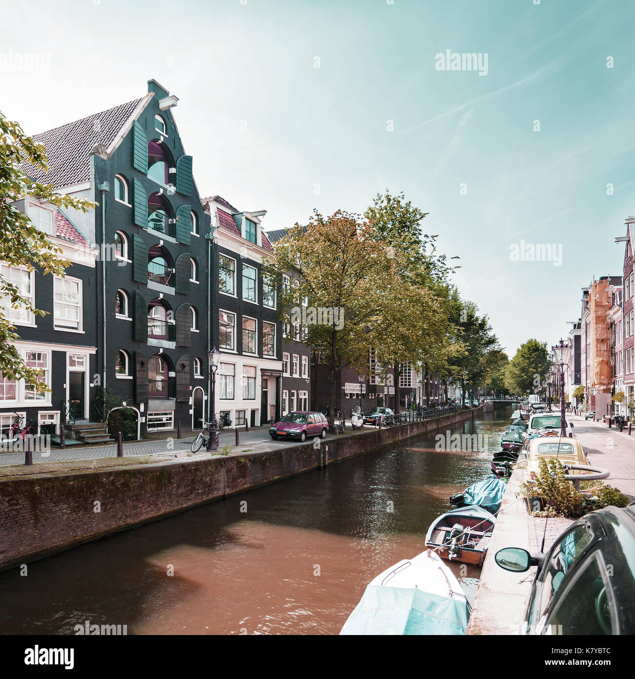 Typical street in Amsterdam with canal and colorful houses. Netherlands ...