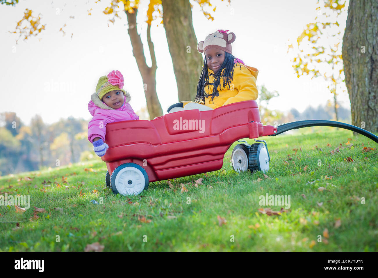 Kids sitting in wagon surrounded by autumn scenery Stock Photo - Alamy