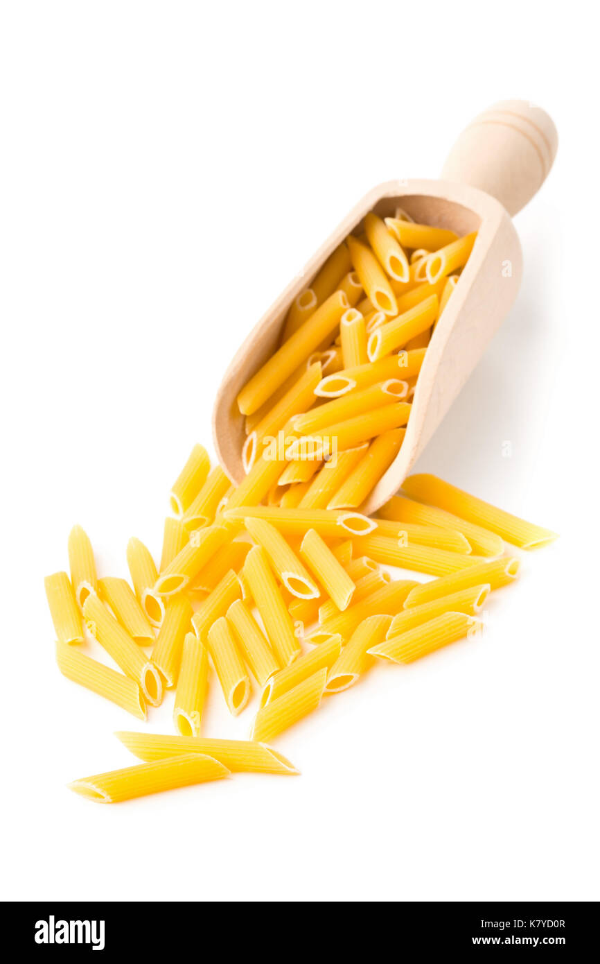 Dry, uncooked, raw penne pasta noodles in wooden scoop on white ...