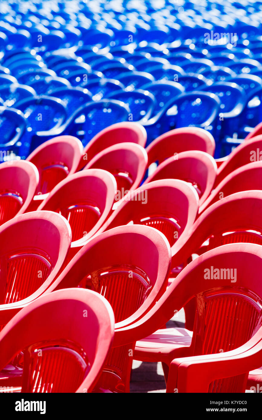 Bright plastic chairs standing in a row Stock Photo - Alamy